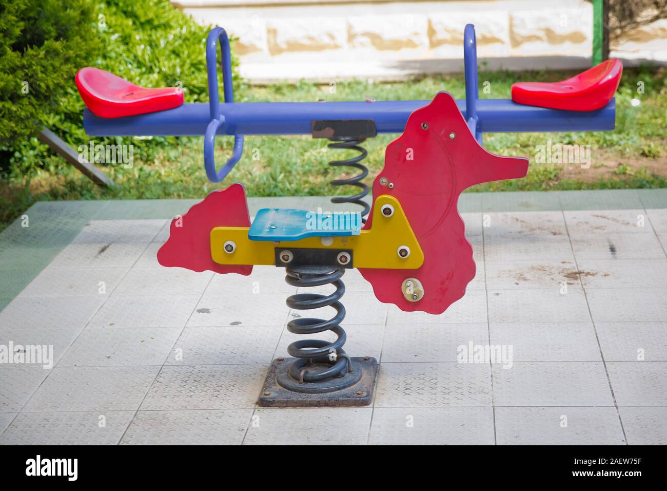 Seesaw on child playground in park. childs horse ride in the playground ...
