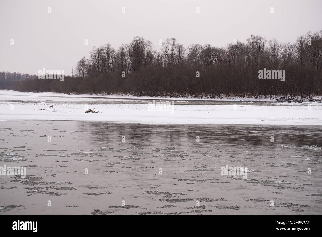 Mountain Russian river in winter. Snow on the shore. Rapid flow of ice ...