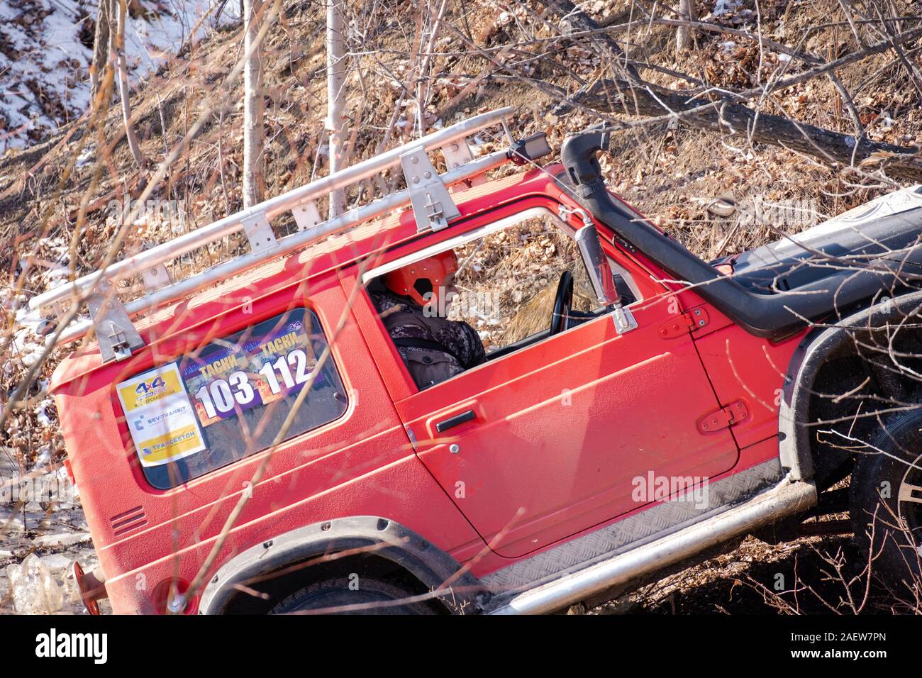 Jeep Suzuki Jimny overcomes obstacles in the forest Stock Photo - Alamy