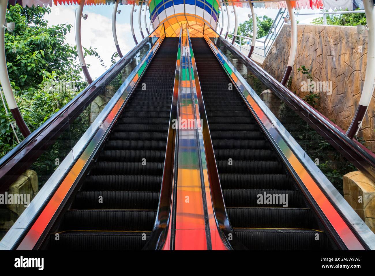 Long escalator for ascent to the second floor. Step up the escalator ...