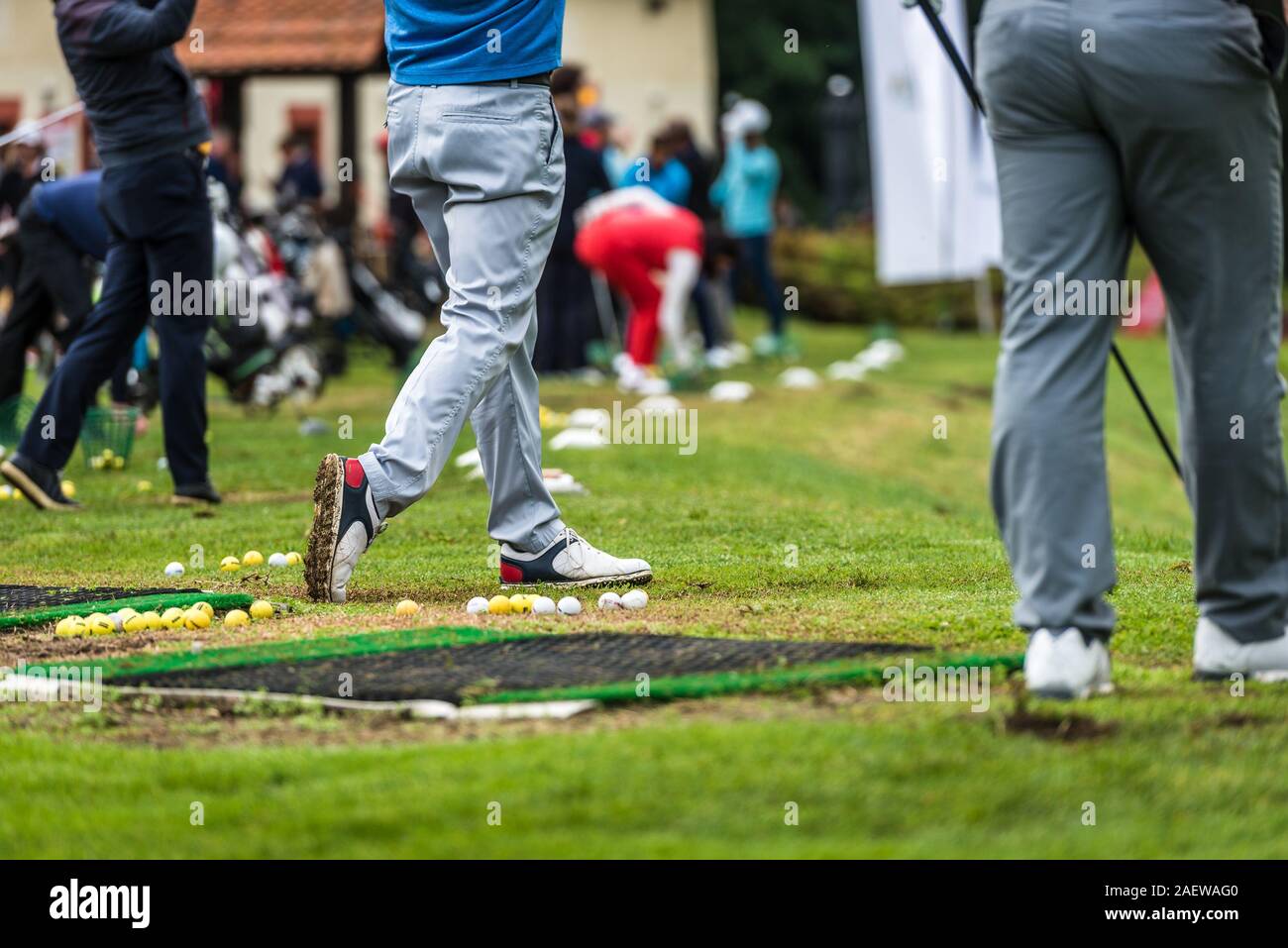 Golfer legs at golf tournament practice swing with golf club. Golf ...