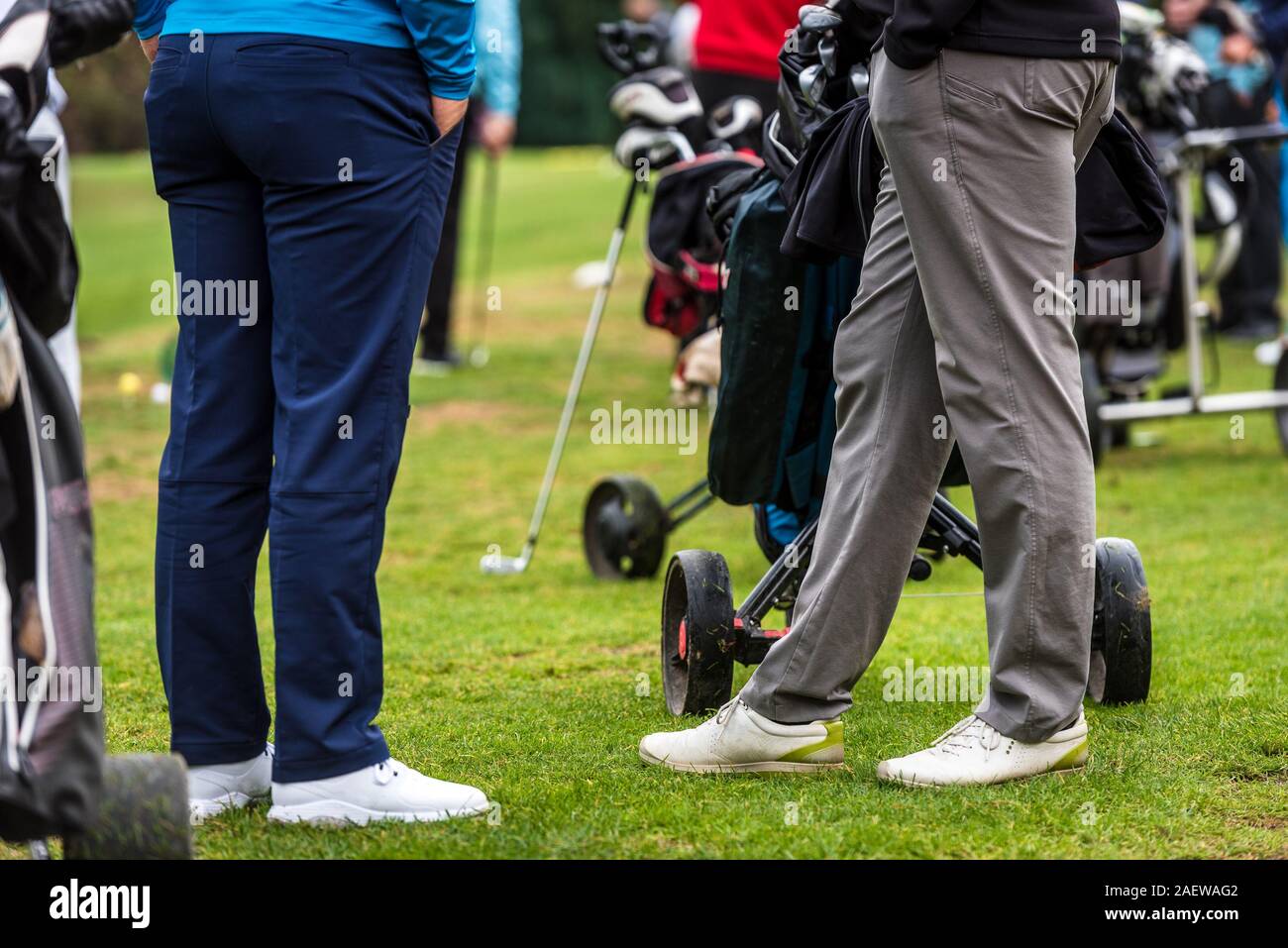 Golfer legs at golf tournament practice swing with golf club. Golf ...