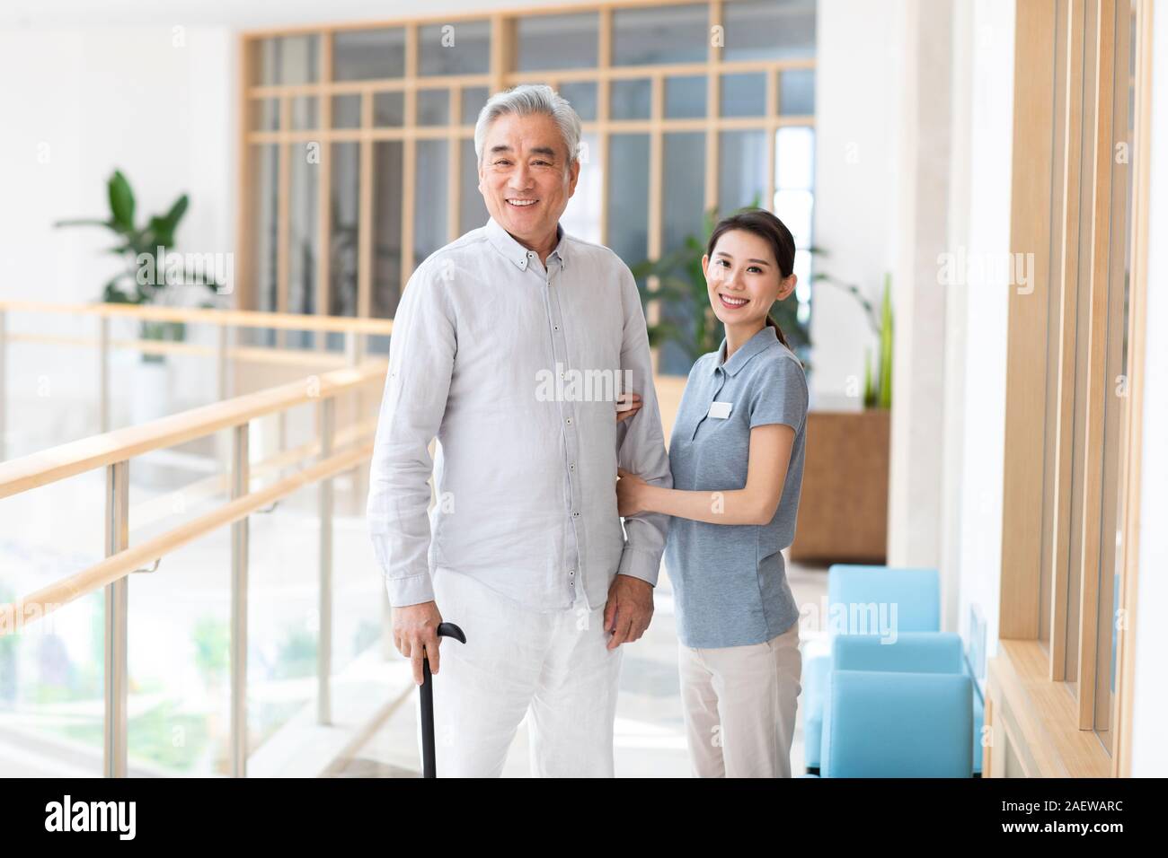 Nursing assistant taking care of senior man Stock Photo - Alamy