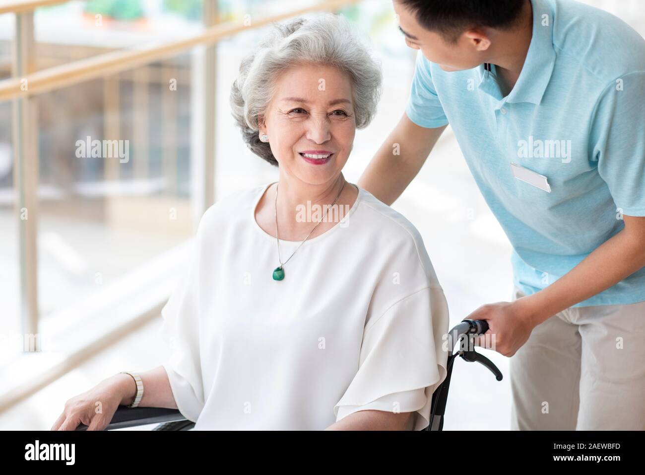 Nursing assistant talking with senior woman in nursing home Stock Photo ...
