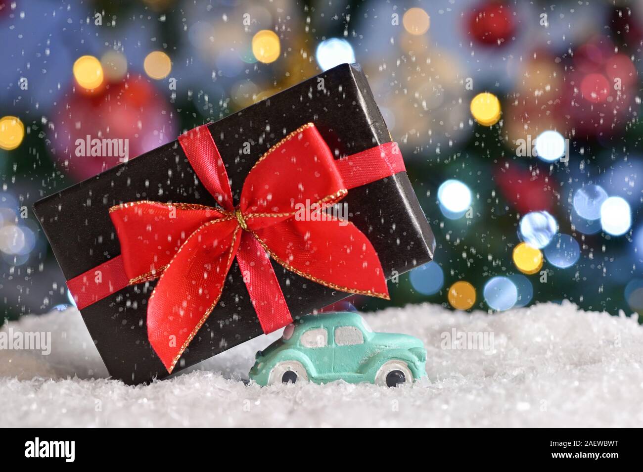 Car Toy Carrying A Christmas Gift Stock Photo - Alamy
