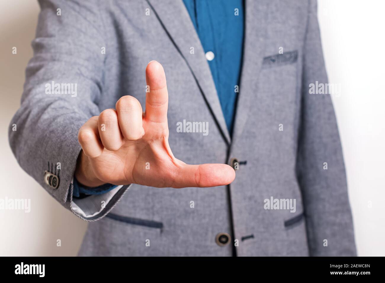 Man wearing suit pointing with his forefinger close-up Stock Photo - Alamy
