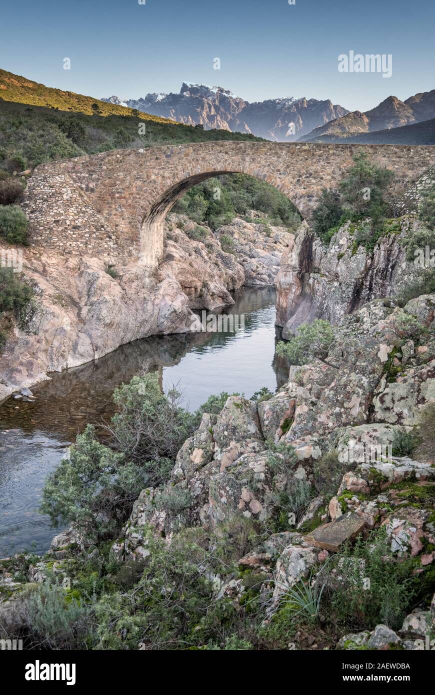 Ancient stone arch of Ponte Vecchiu Genoese bridge over the crystal ...