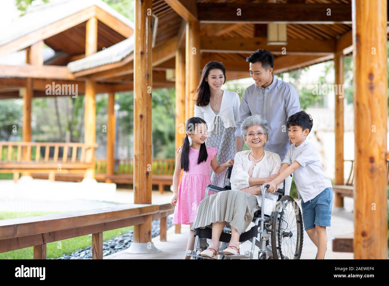 Happy family relaxing in pavilion Stock Photo - Alamy