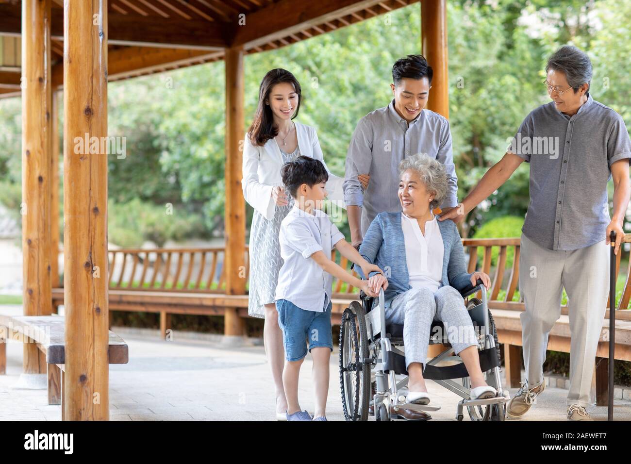 Happy family walking in corridor Stock Photo - Alamy