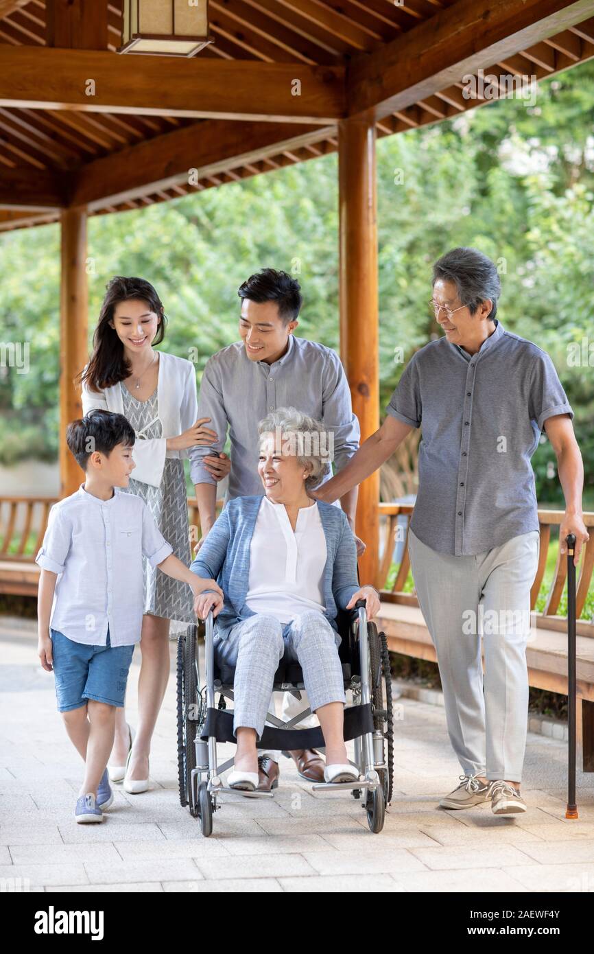 Happy family walking in corridor Stock Photo - Alamy