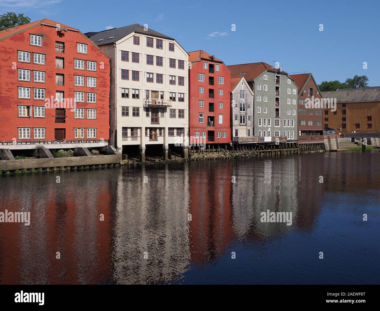 Famous buildings reflected in water at Nidelva river in european ...