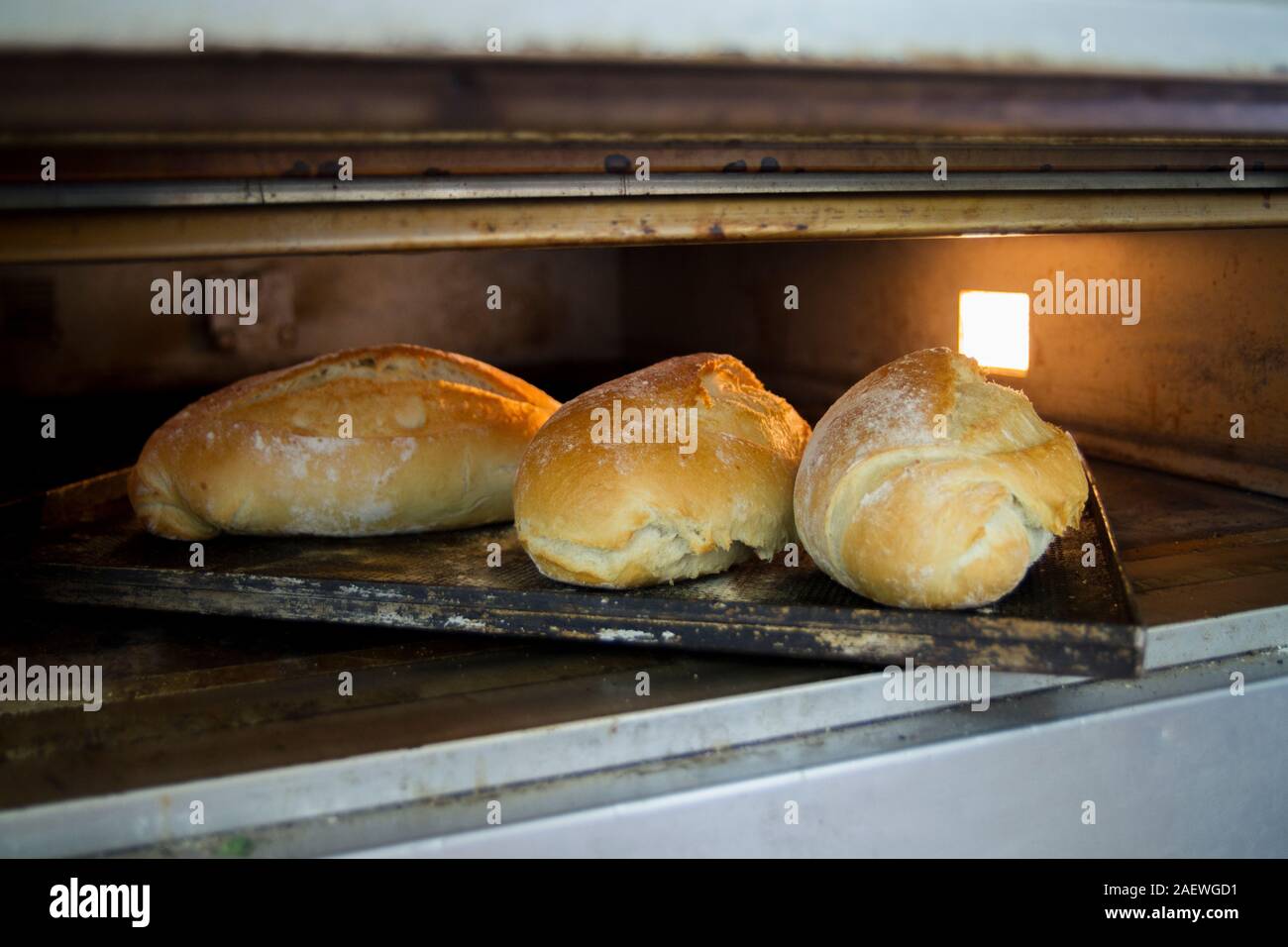 Three loaves of bread in the baking oven Stock Photo - Alamy
