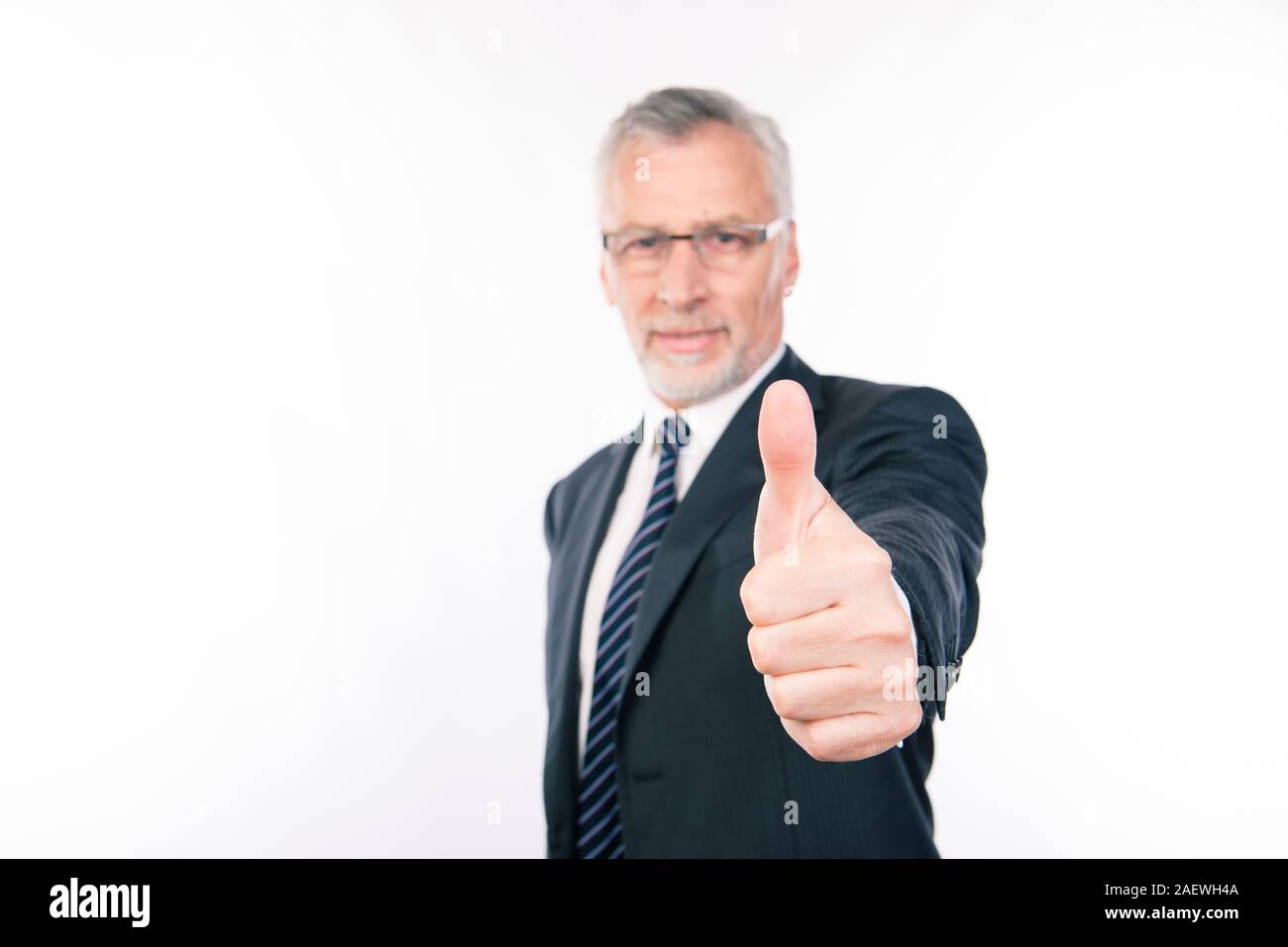 Confident aged businessman showing thumb up Stock Photo - Alamy Confident aged businessman showing thumb up Stock Photo - Alamy