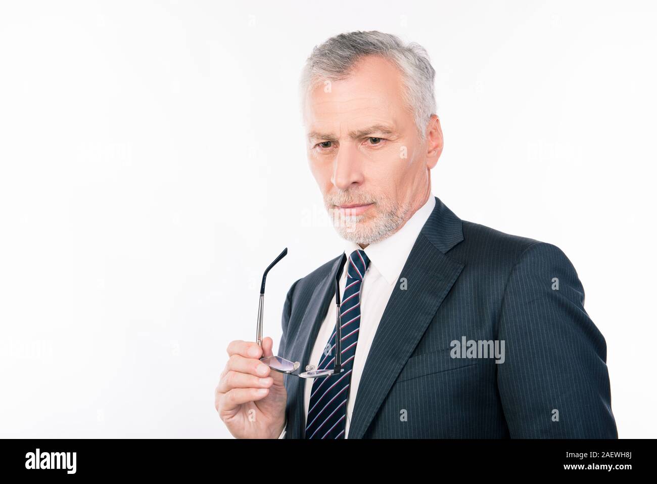 handsome intelligent old man in business suit holding glasses and ...