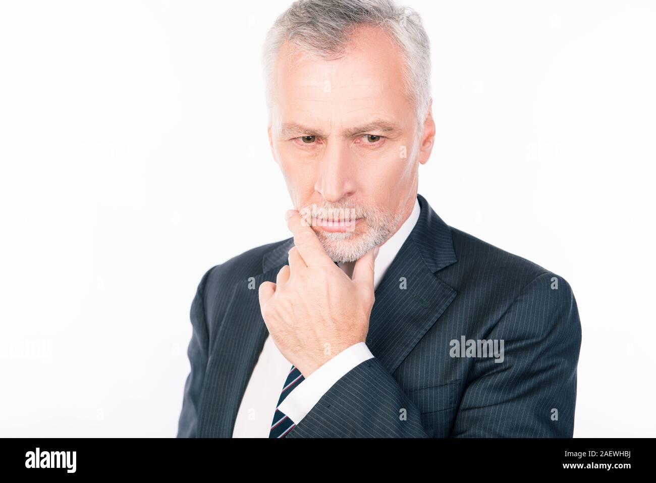 Old intelligent businessman ponders putting his hand on chin Stock ...