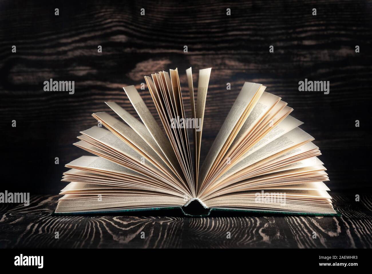 Open old book on wood table brown background Stock Photo - Alamy