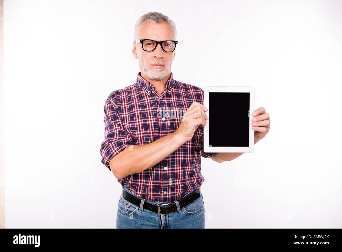 Confident gray aged man with glasses showing a screen of tablet Stock ...