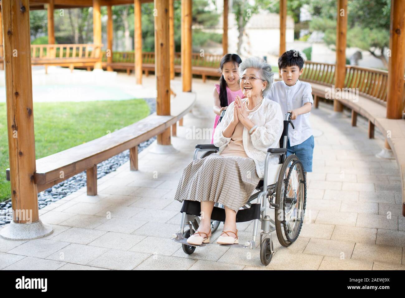 Child pushing wheelchair hi-res stock photography and images - Alamy