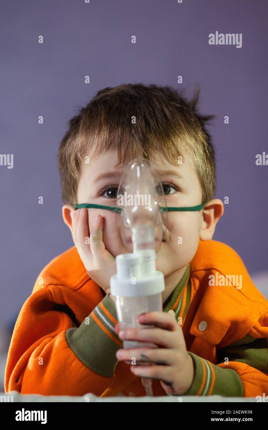 Little boy in a mask, treatments respiratory tract with a nebulizer at ...