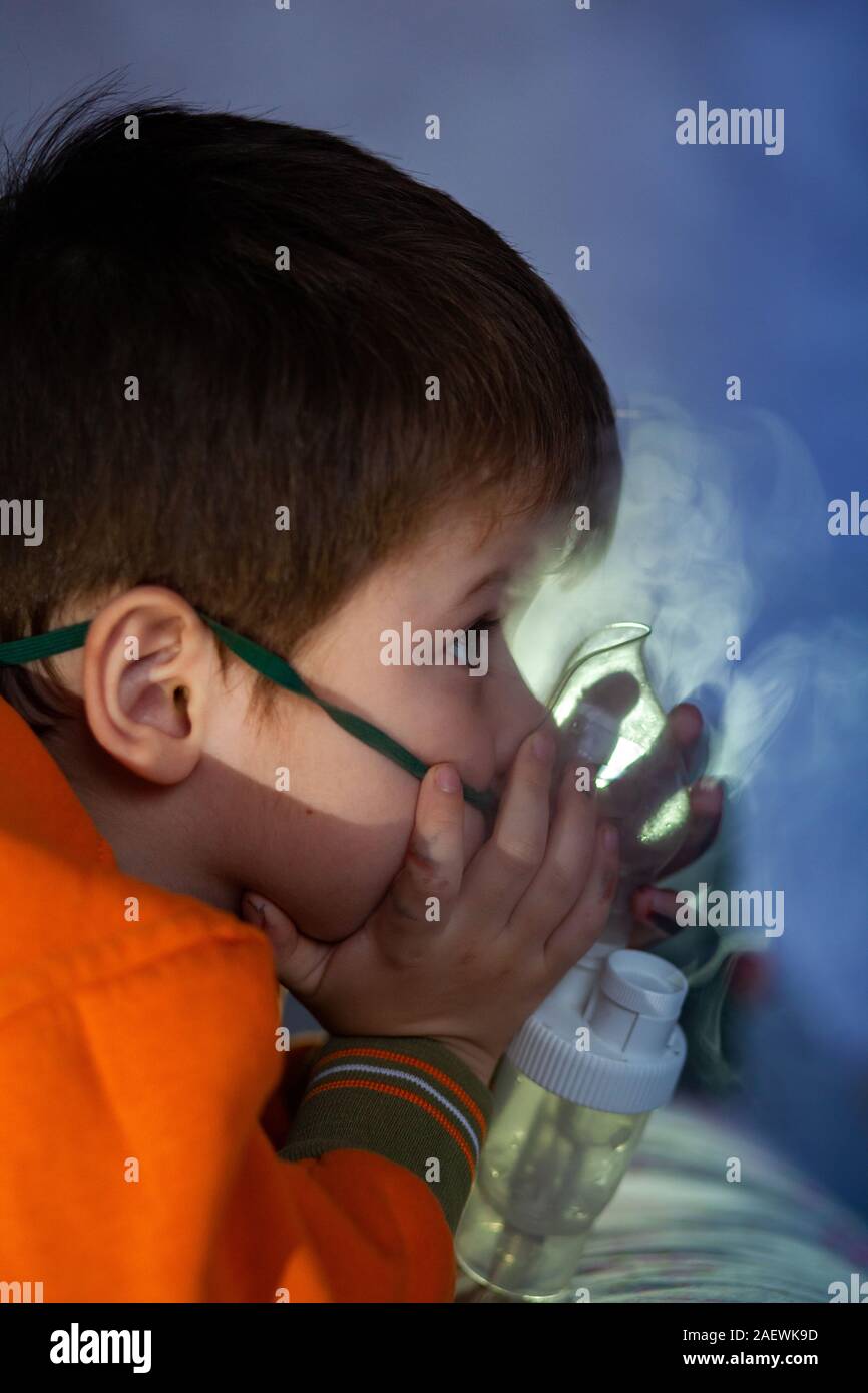 Little boy in a mask, treatments respiratory tract with a nebulizer at ...