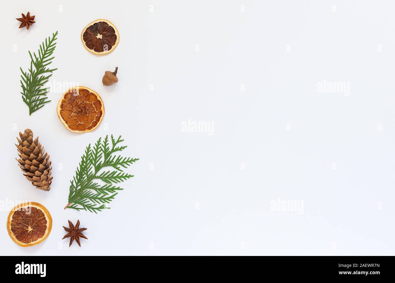 Fir twigs and star anise, tree cone with dry citrus on a white ...