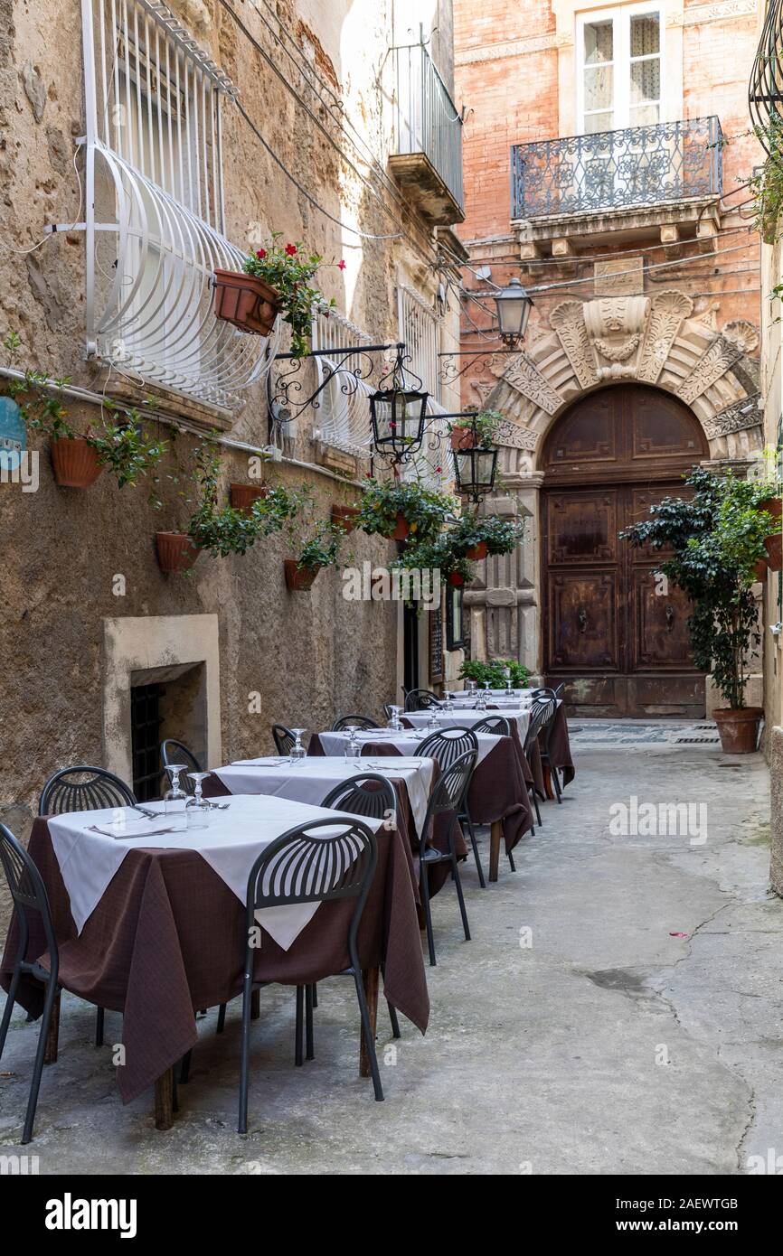 dining tables set in small courtyard outside italian restaurant Stock ...