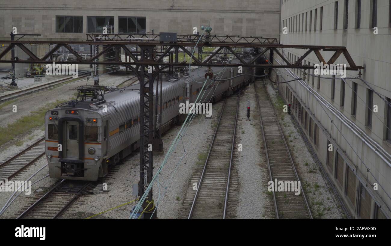 Overhead view of large passenger commuter train switching tracks ...