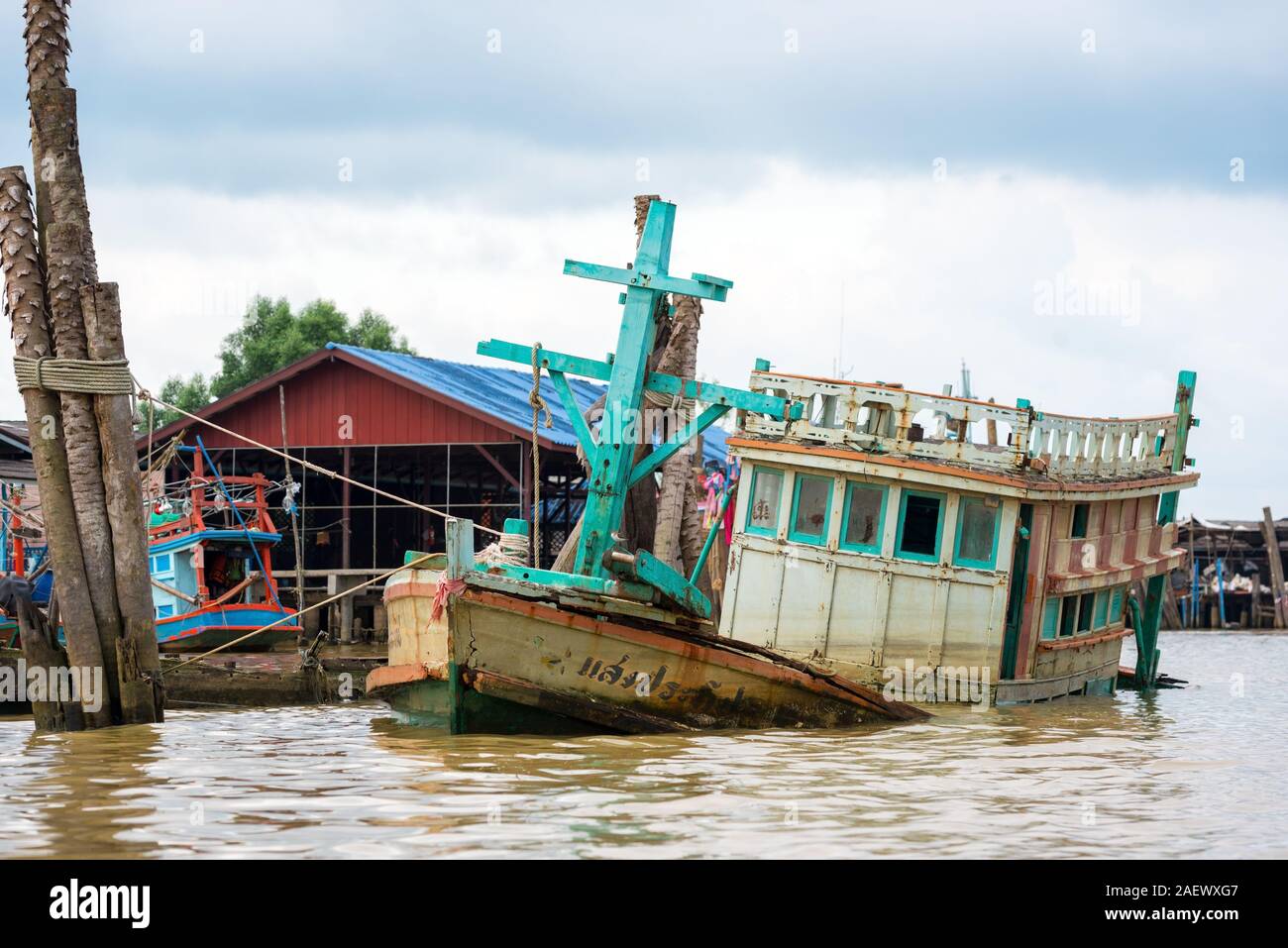 A typical view of thailand river life. Ruined fishing boat Stock Photo ...