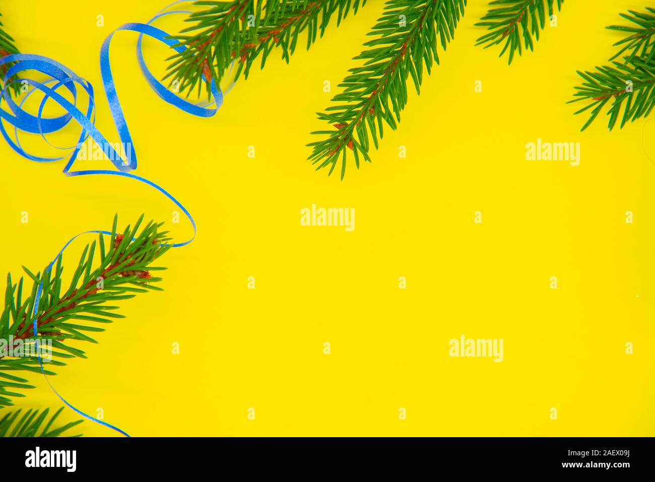 Fir branches and bright streamers on a yellow background Stock Photo ...