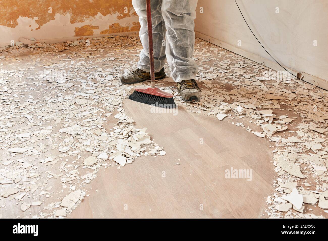 Builder sweeping the floor after renovation Stock Photo - Alamy