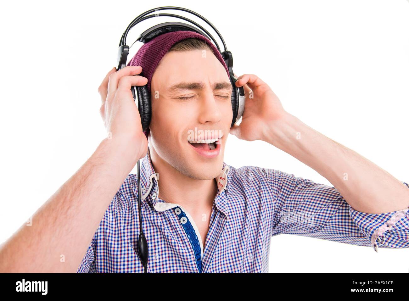 Portrait of man in cap and headphones listening music and singing Stock ...