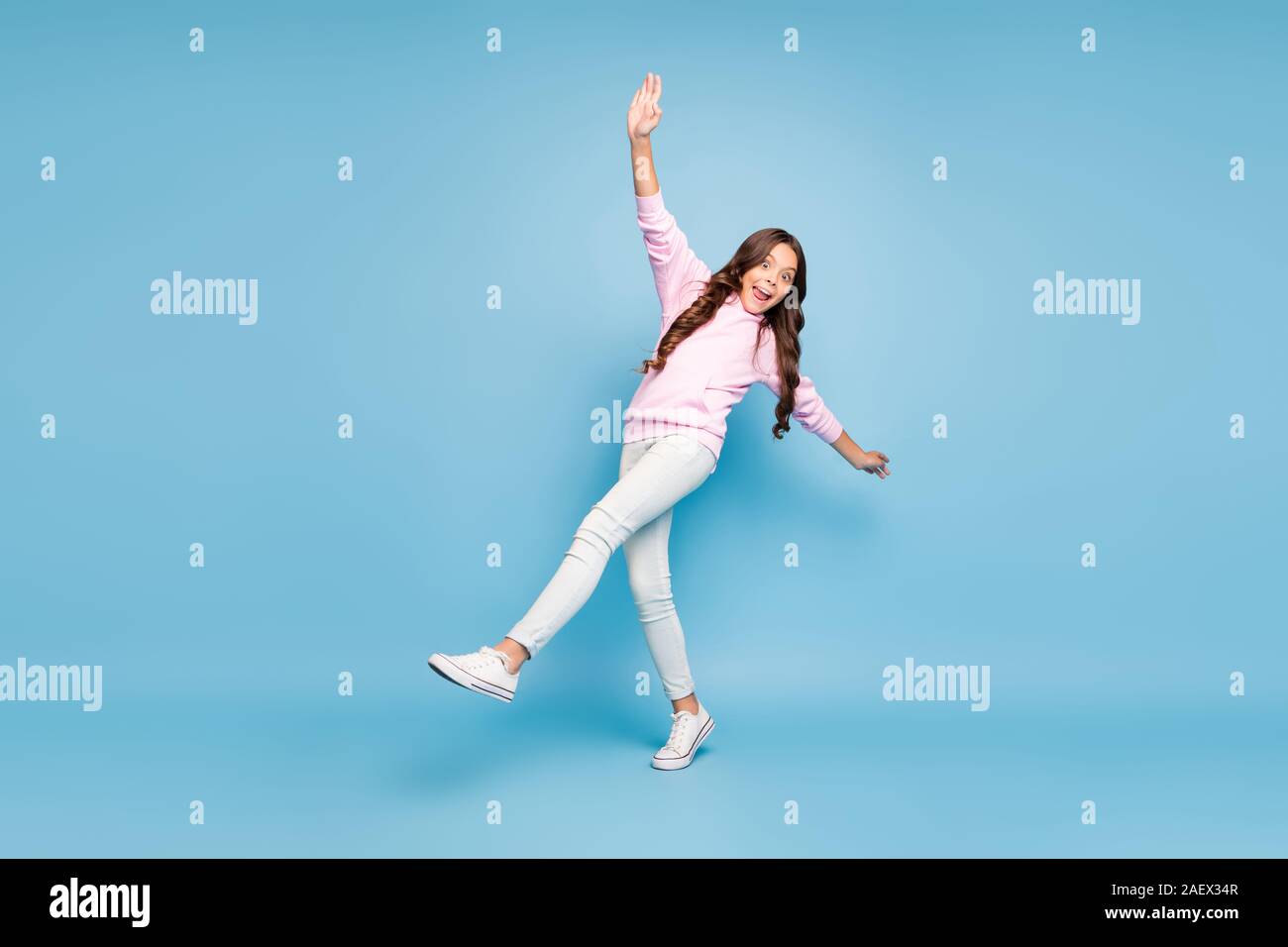Full length body size turned photo of positive pink cheerful ecstatic overjoyed preteen ...