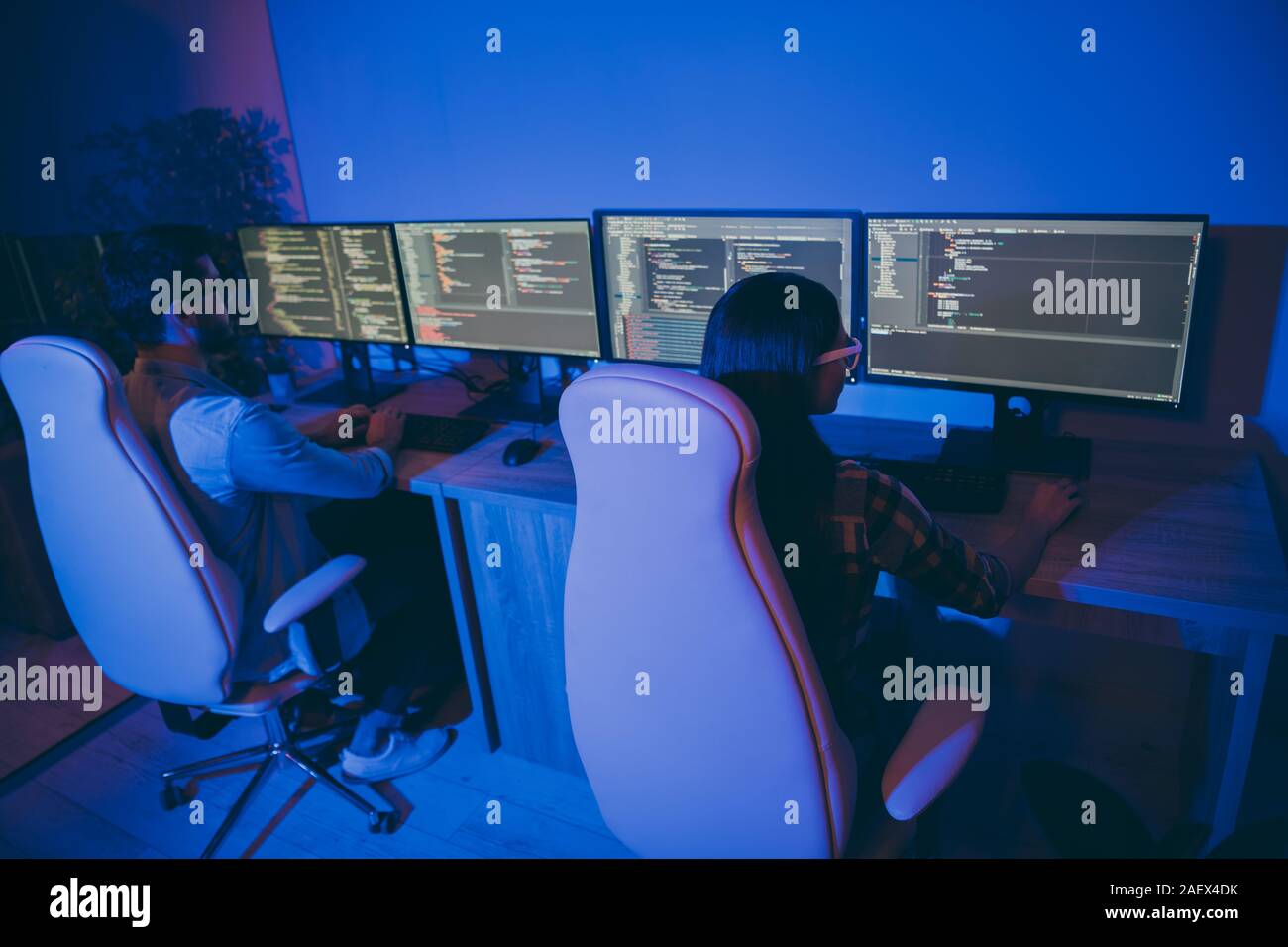 Rear behind view photo of it specialist guy lady business people night ...