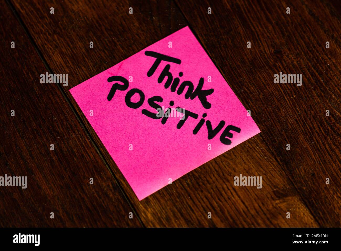 Writing on colorful sticky note Think positive. Text with Think ...