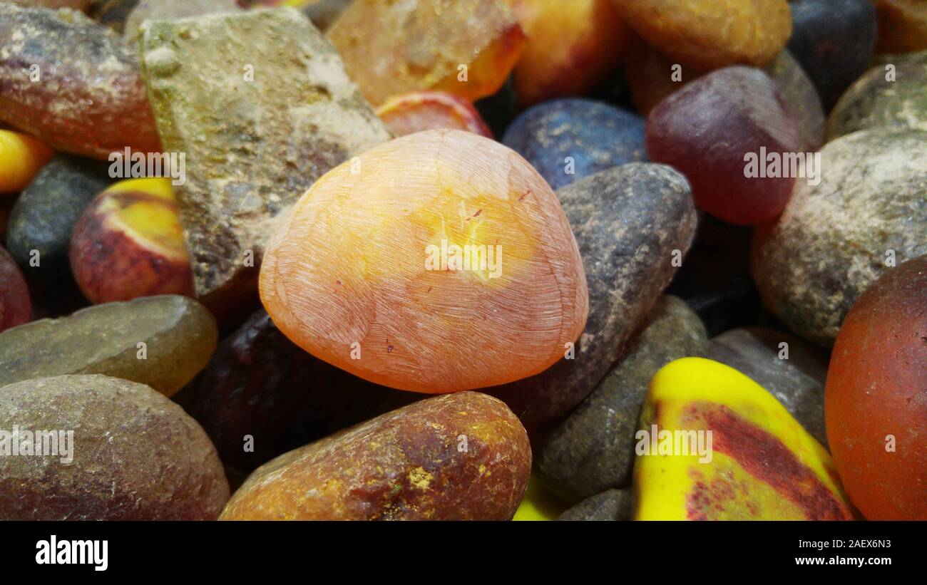 A close-up of the amber wax raw materials that can be honed to create a ...