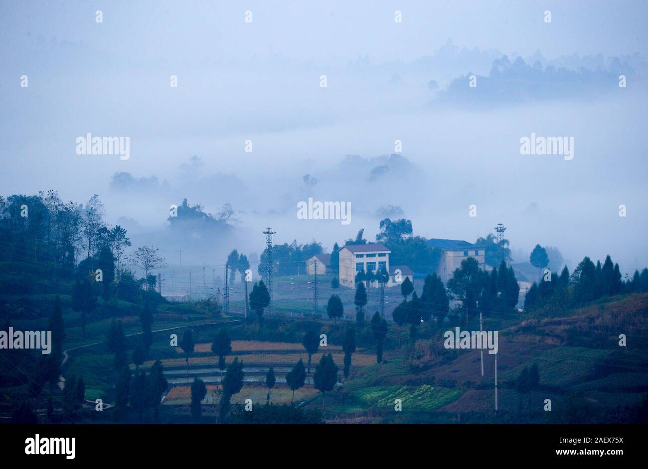 Landscape of mountains and villages shrouded by mist in the early ...