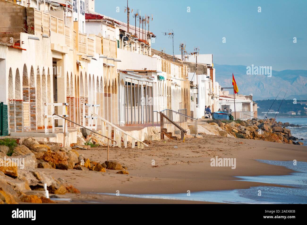 Beach front housing and people sea fishing at Playa De Pinet, La Marina ...