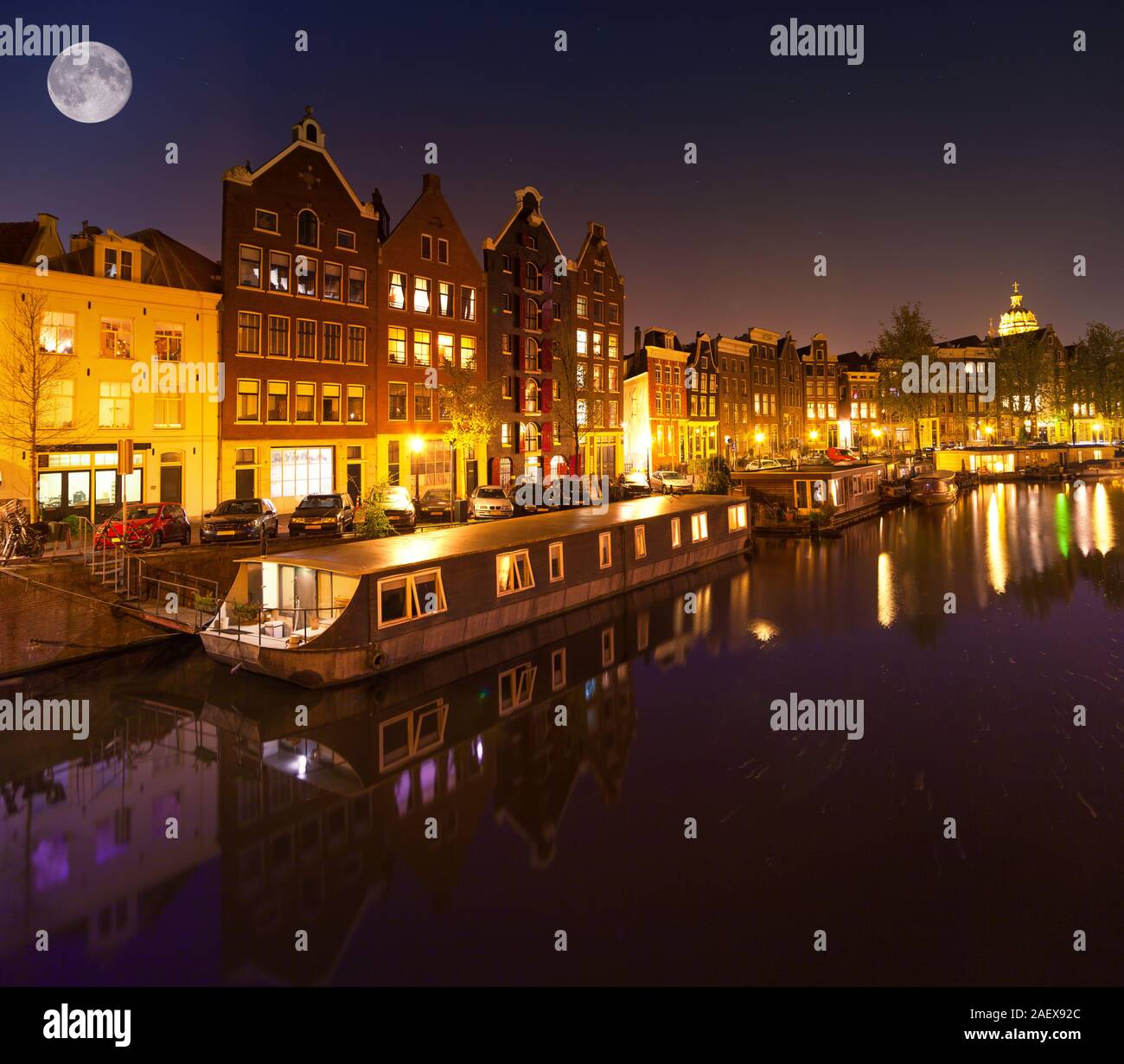 Beautiful calm night view of Amsterdam city. Night time illuminations ...