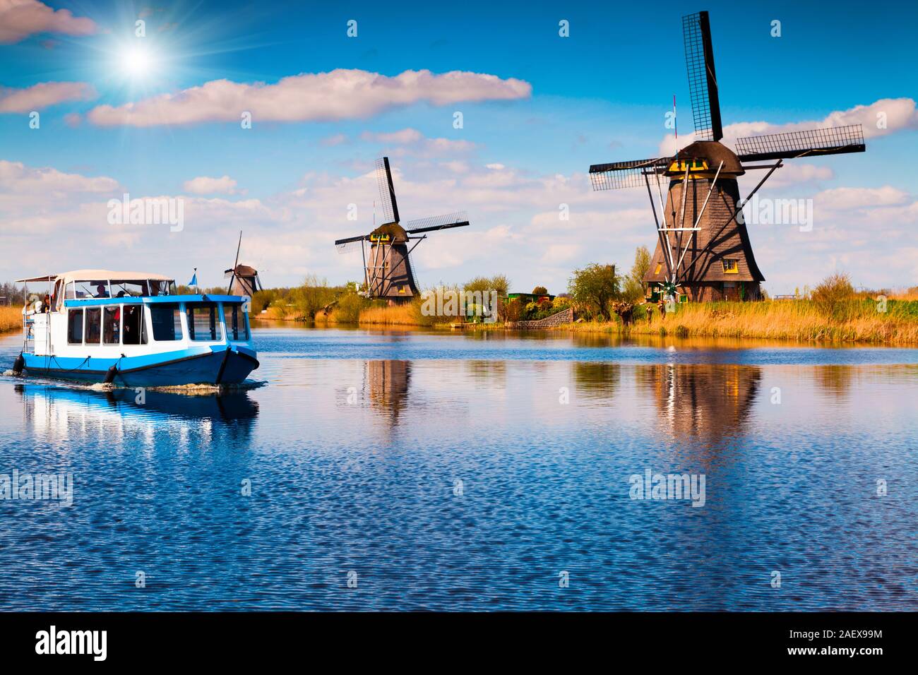 Walking boat on the famous Kinderdijk canal with windmills. Old Dutch ...
