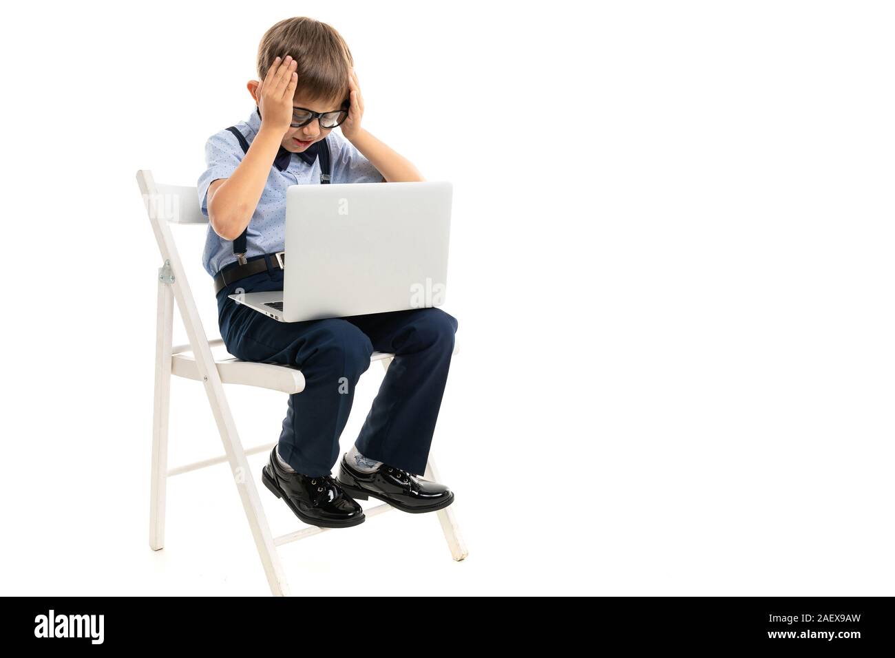 Cute boy sitting computer desk Cut Out Stock Images & Pictures - Alamy