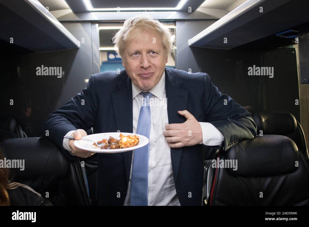 Prime Minister Boris Johnson eats a pie on his campaign bus following a ...