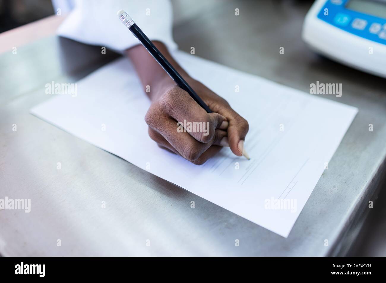 Scientist hand writing notes in white sheet Stock Photo - Alamy