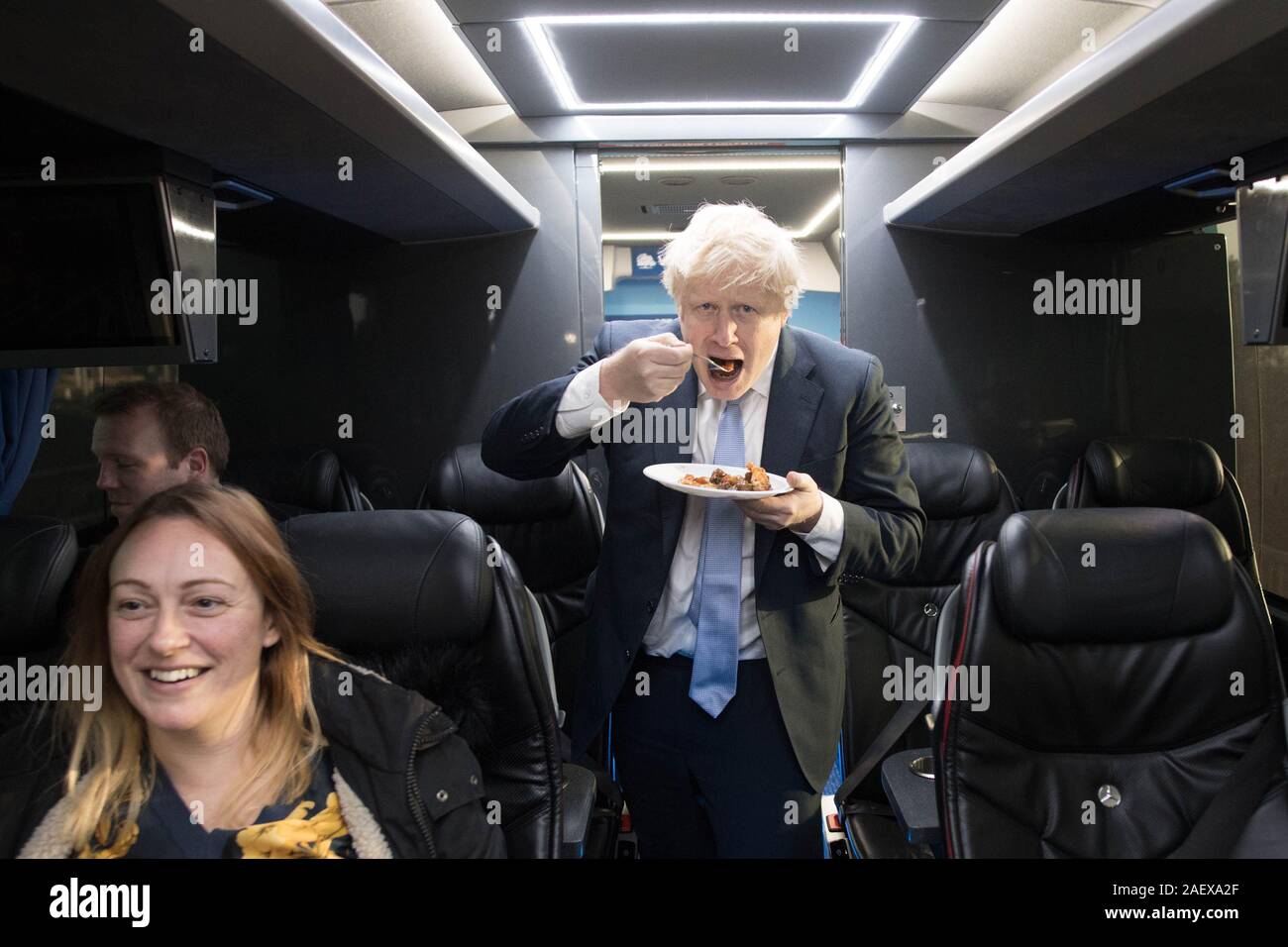 Prime Minister Boris Johnson eats a pie on his campaign bus following a ...