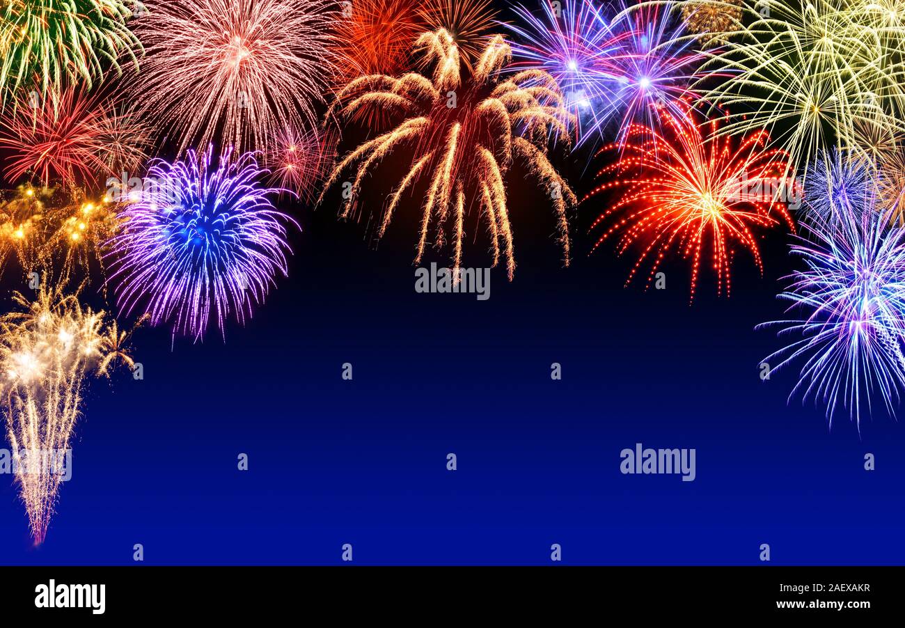 Gorgeous multi-colored fireworks display on dark blue night sky, with ...