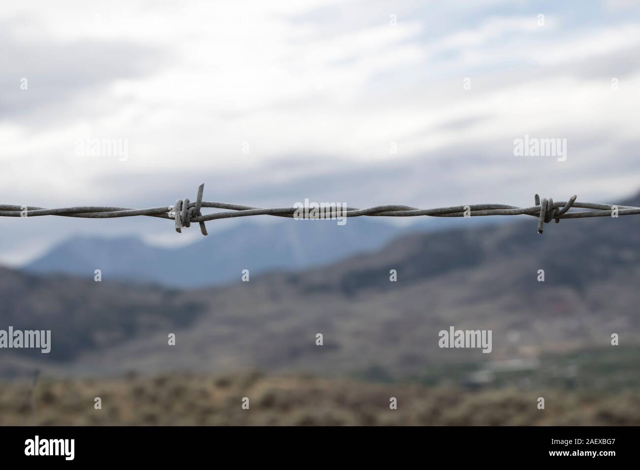 fence sling wire with mountain and tree background Stock Photo - Alamy