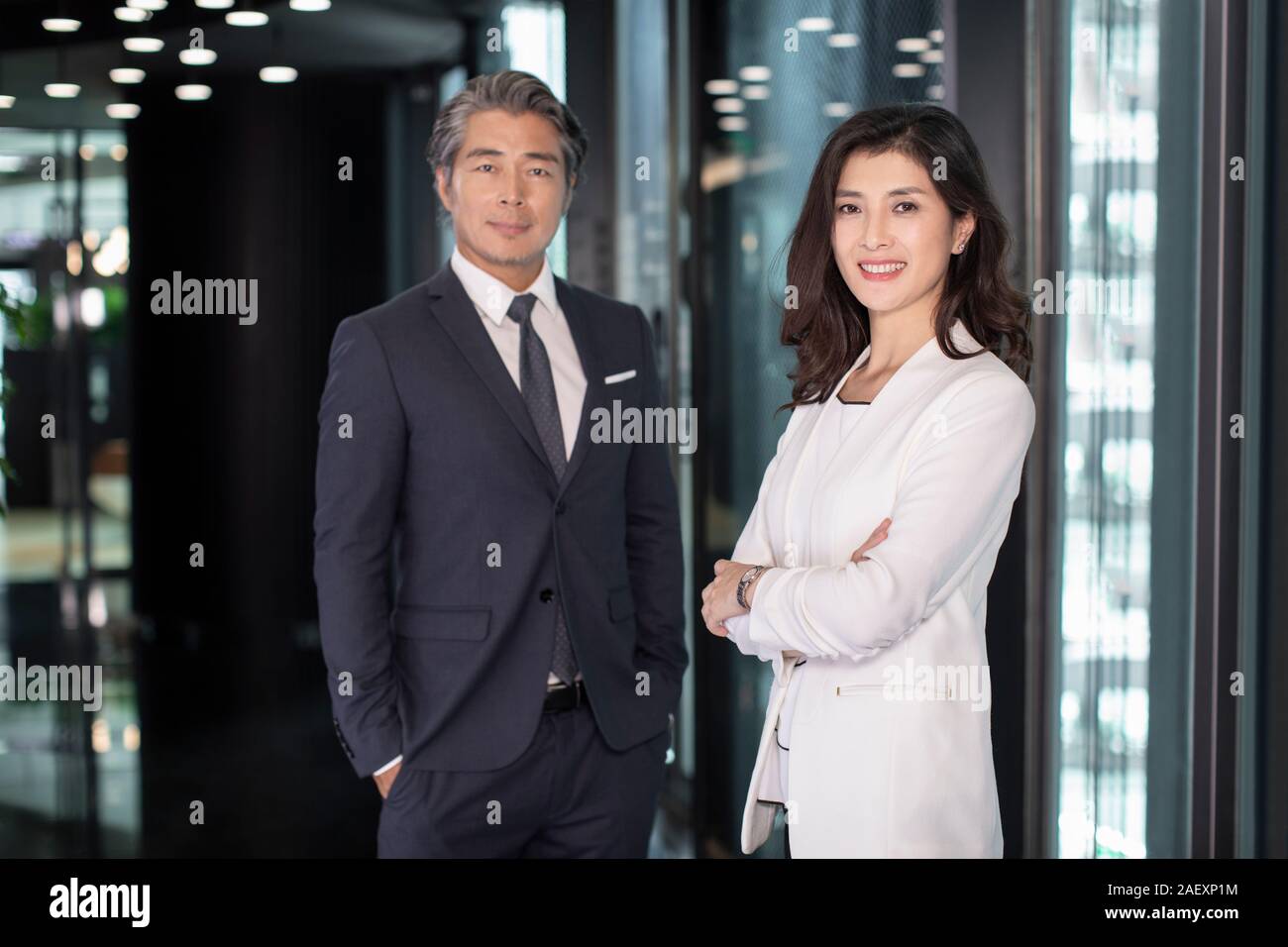 Portrait of two successful business people in office Stock Photo - Alamy