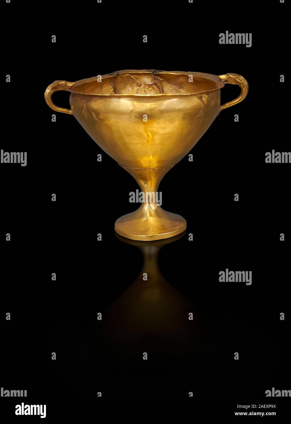 Mycenaean gold goblet with two handles ening with a dogs head biting ...