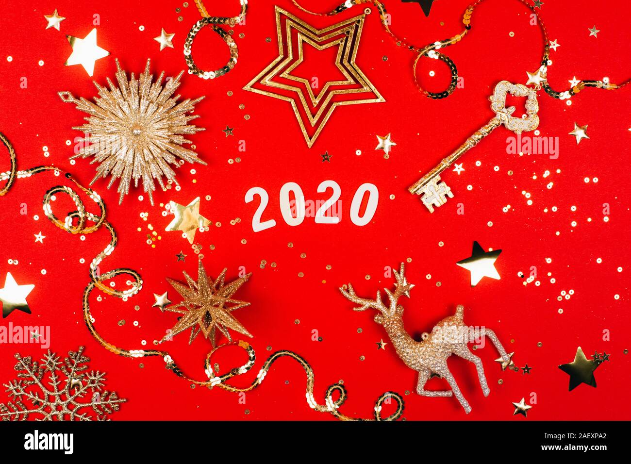 2020 on red background with sparkles. Flat lay style Stock Photo - Alamy