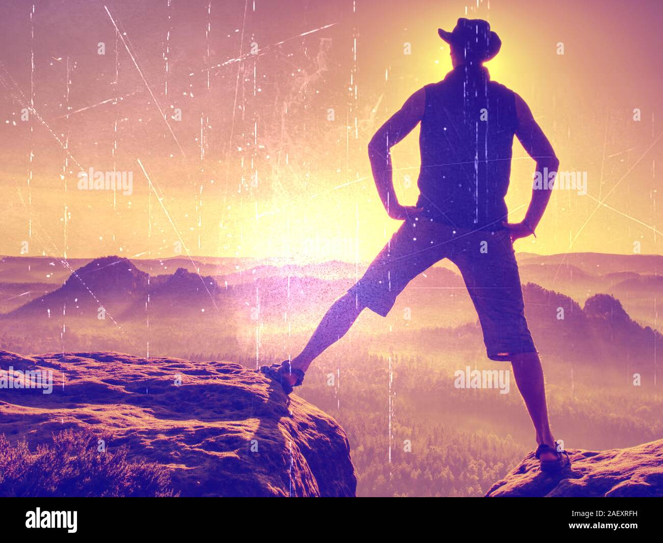 Climber looking into landscape from sharp summit. Abstract filter Stock ...