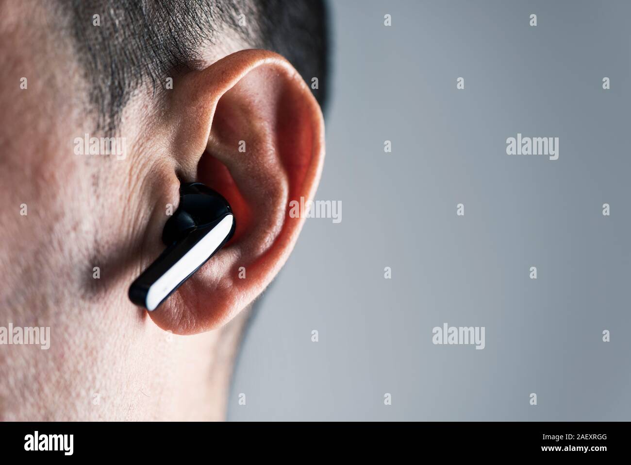 Man using cordless earbuds hi-res stock photography and images - Alamy